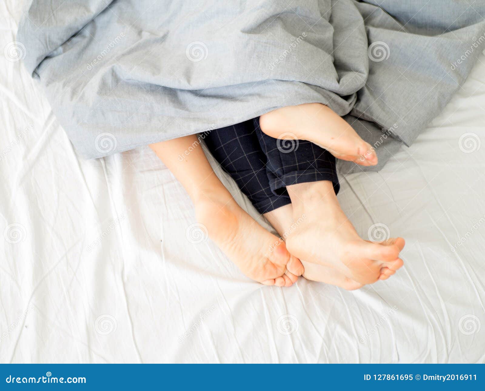 Close Up of Four Feet in a Bed Stock Image - Image of closeup, human ...