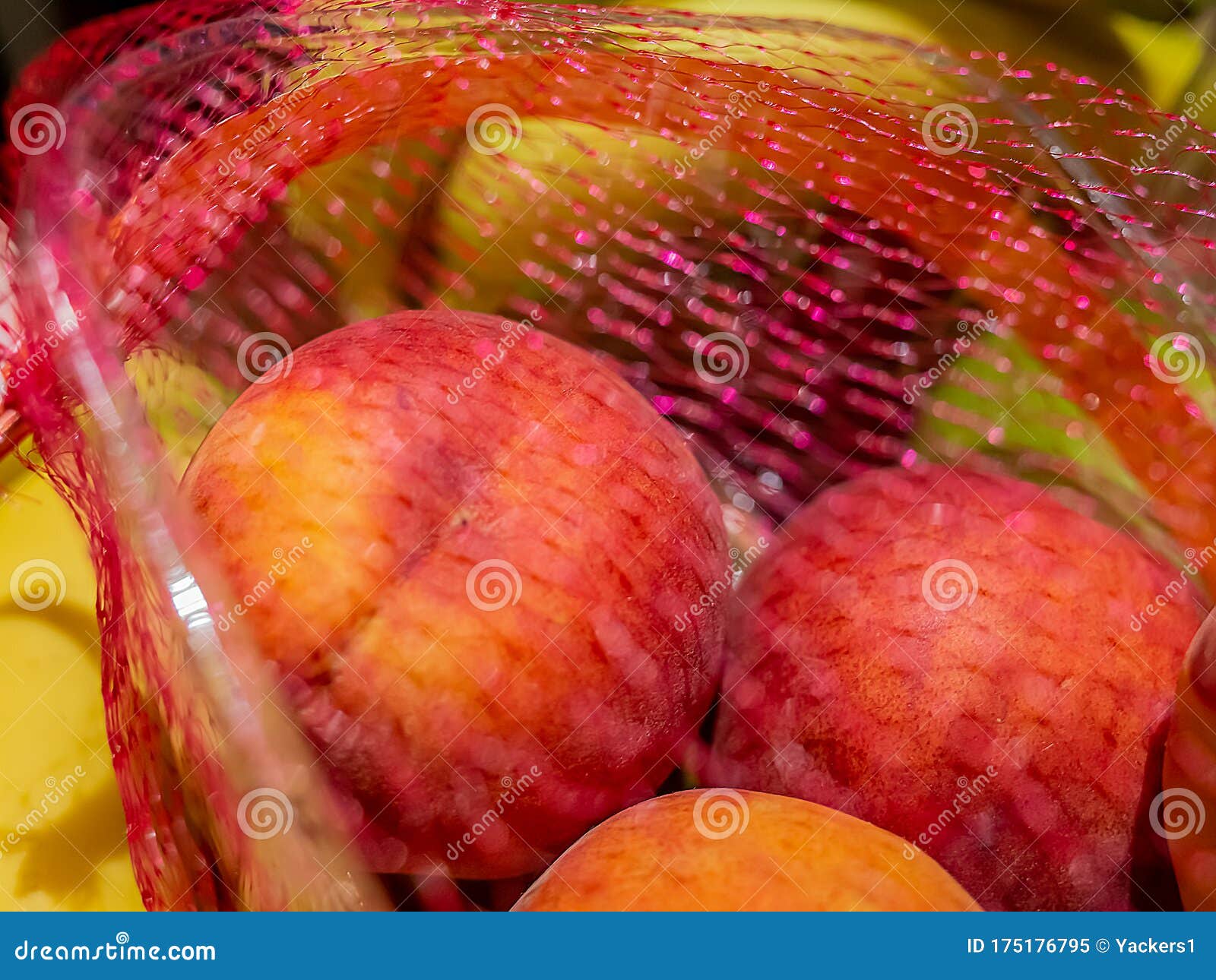 Fresh Peaches in a Plastic Container Surrounded by Red Netting Stock ...