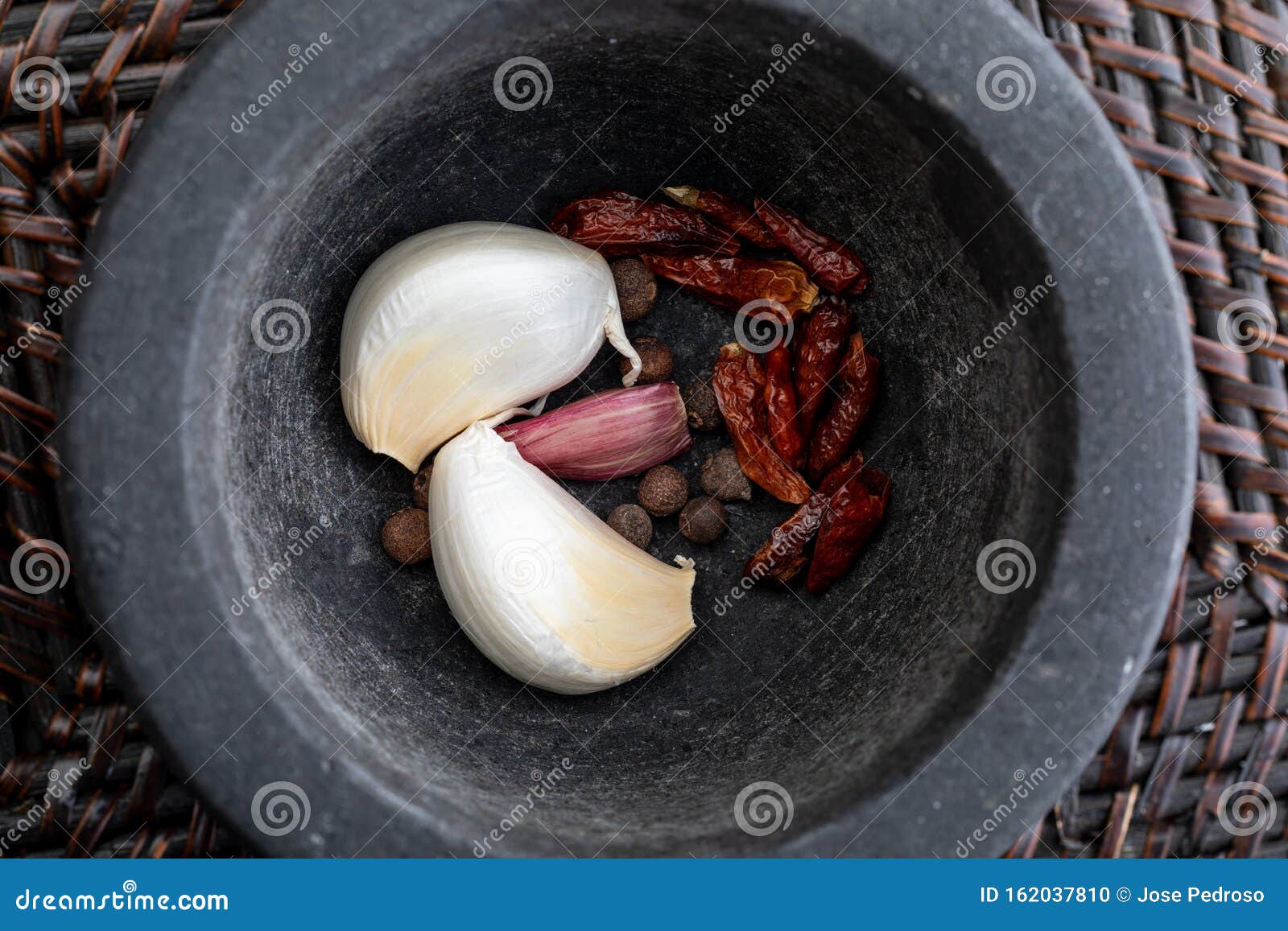 Close Up with Garlic, Black Pepper and Chilli Peppers. in Stone Mortar ...