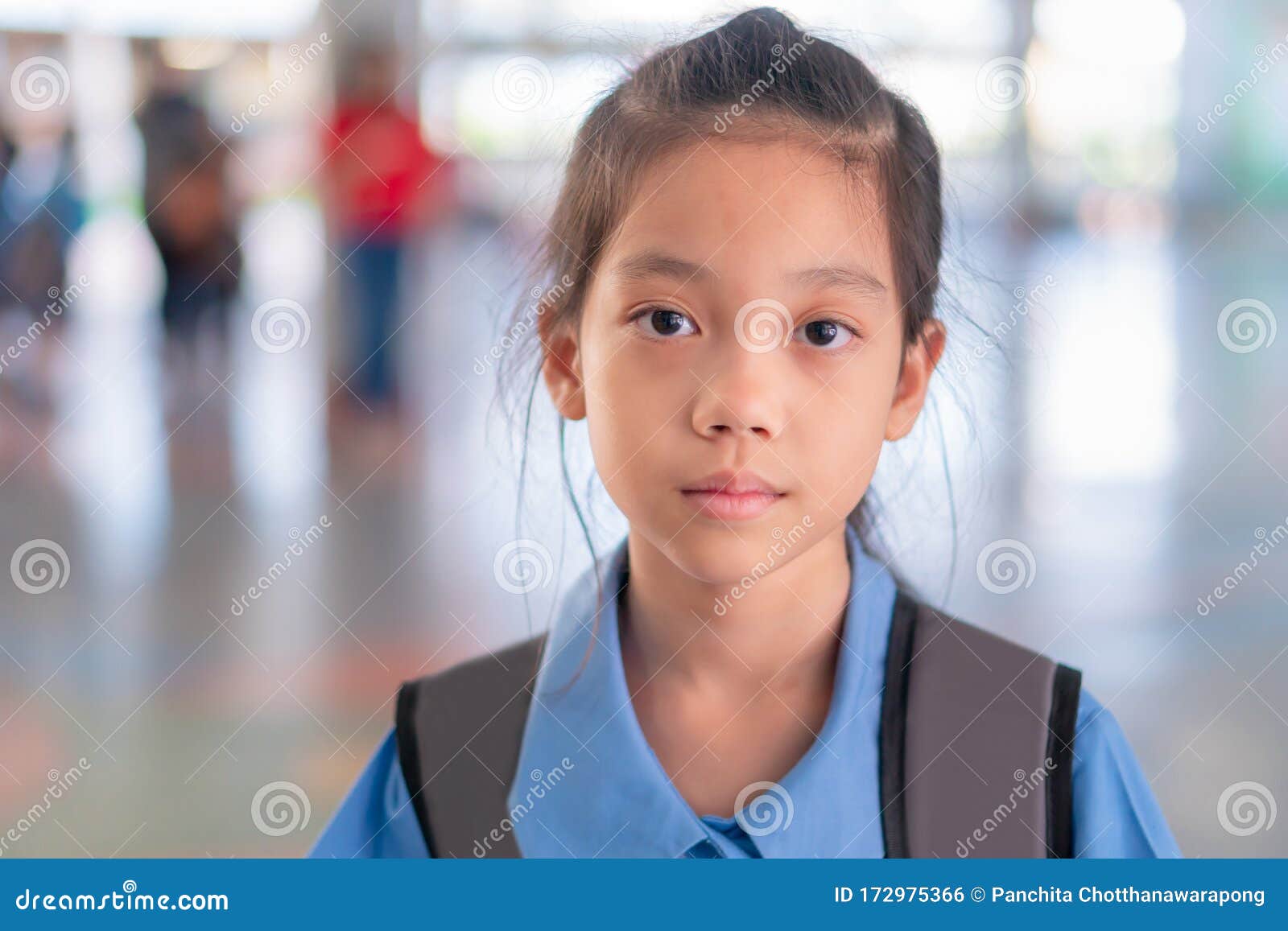 Close-up of Girl in School Uniform Looking at Camera Over Blurred ...
