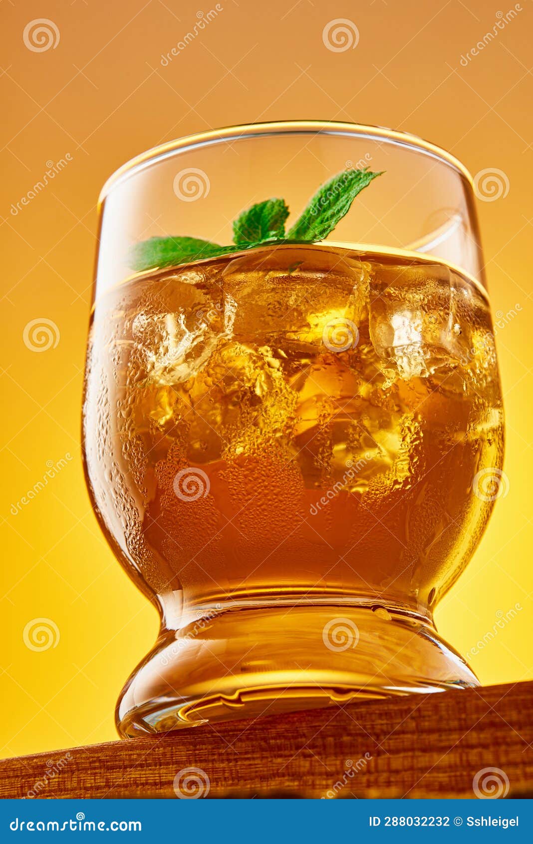 Close Up Glass of Refreshing Iced Tea with Ice Cubes and Mint Leaves ...