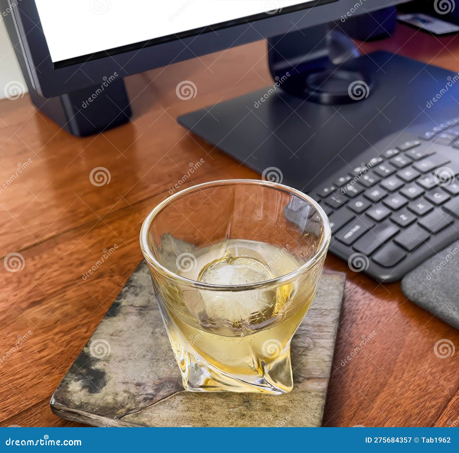 Close Up of a Glass of Whiskey Drink with Round Ice Cube on Work ...