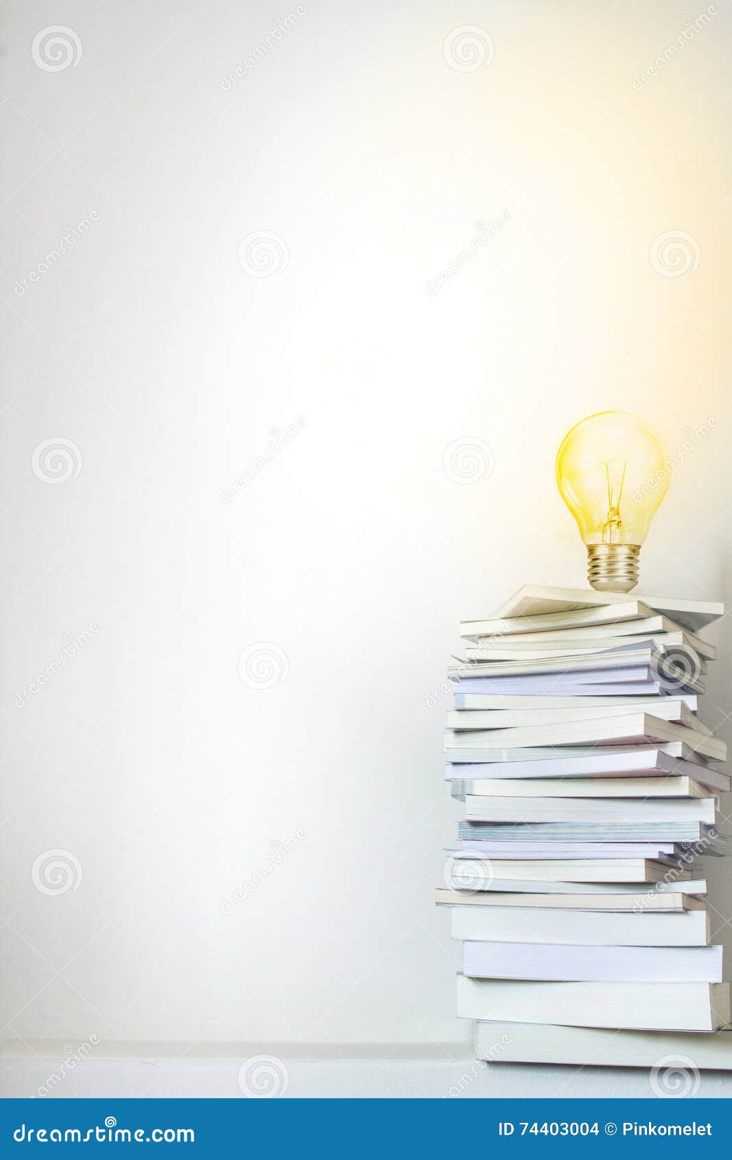 Close Up Glowing Light Bulb on Book Stacked with Concrete Wall Stock ...
