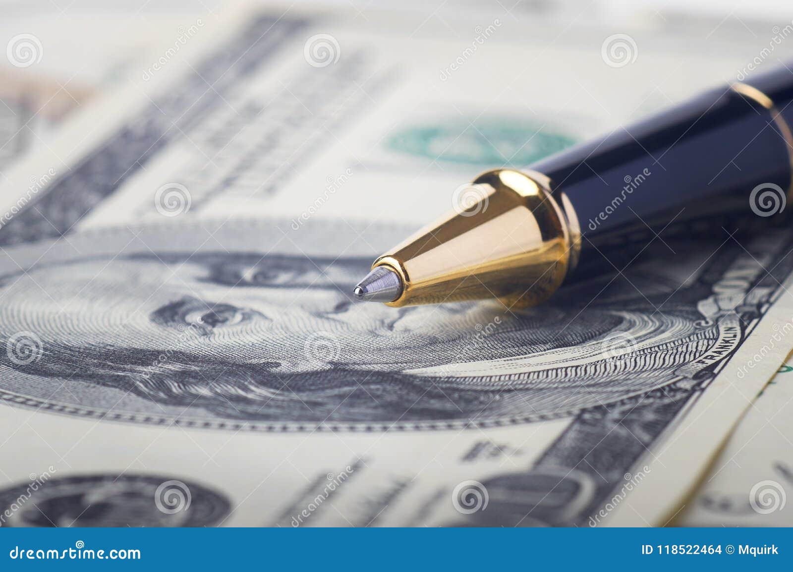 Close-up of a Gold and Black Pen on 100 Dollar Bills Stock Photo ...