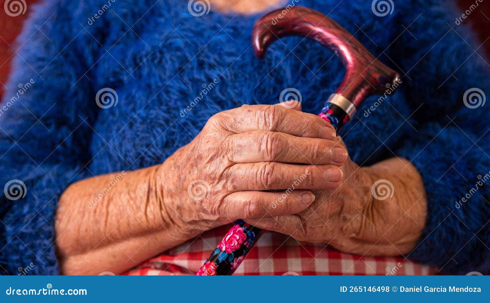Close Up Of Grandma Holding A Walking Stick While She Sitting On The