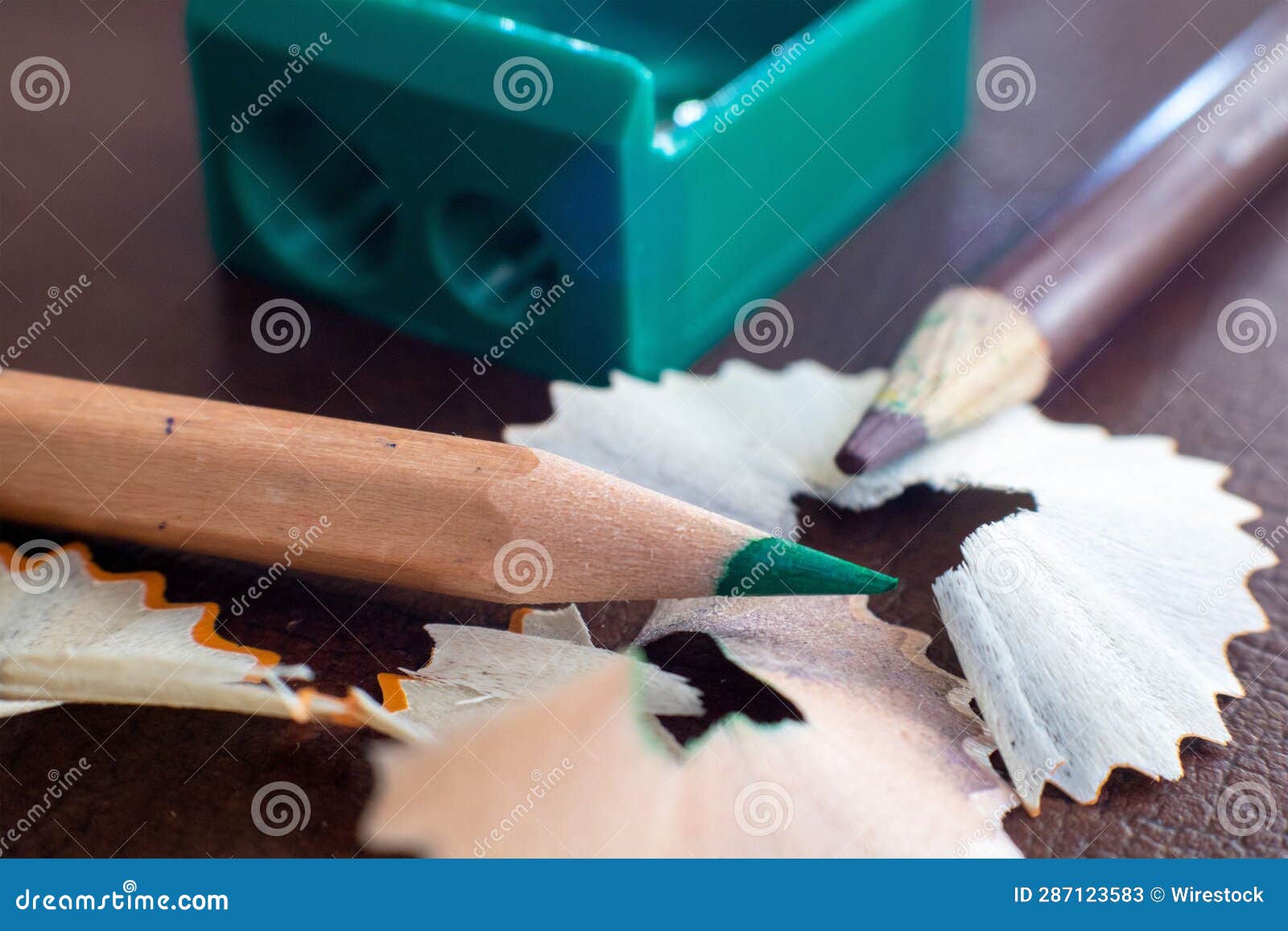 Close-up of a Green Pencil Sharpened in a Sharpener, with Shavings of ...