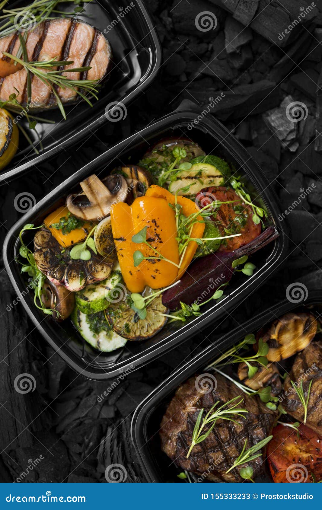 Close Up of Grillled Vegetables, Meat and Fish in Black Boxes Stock ...