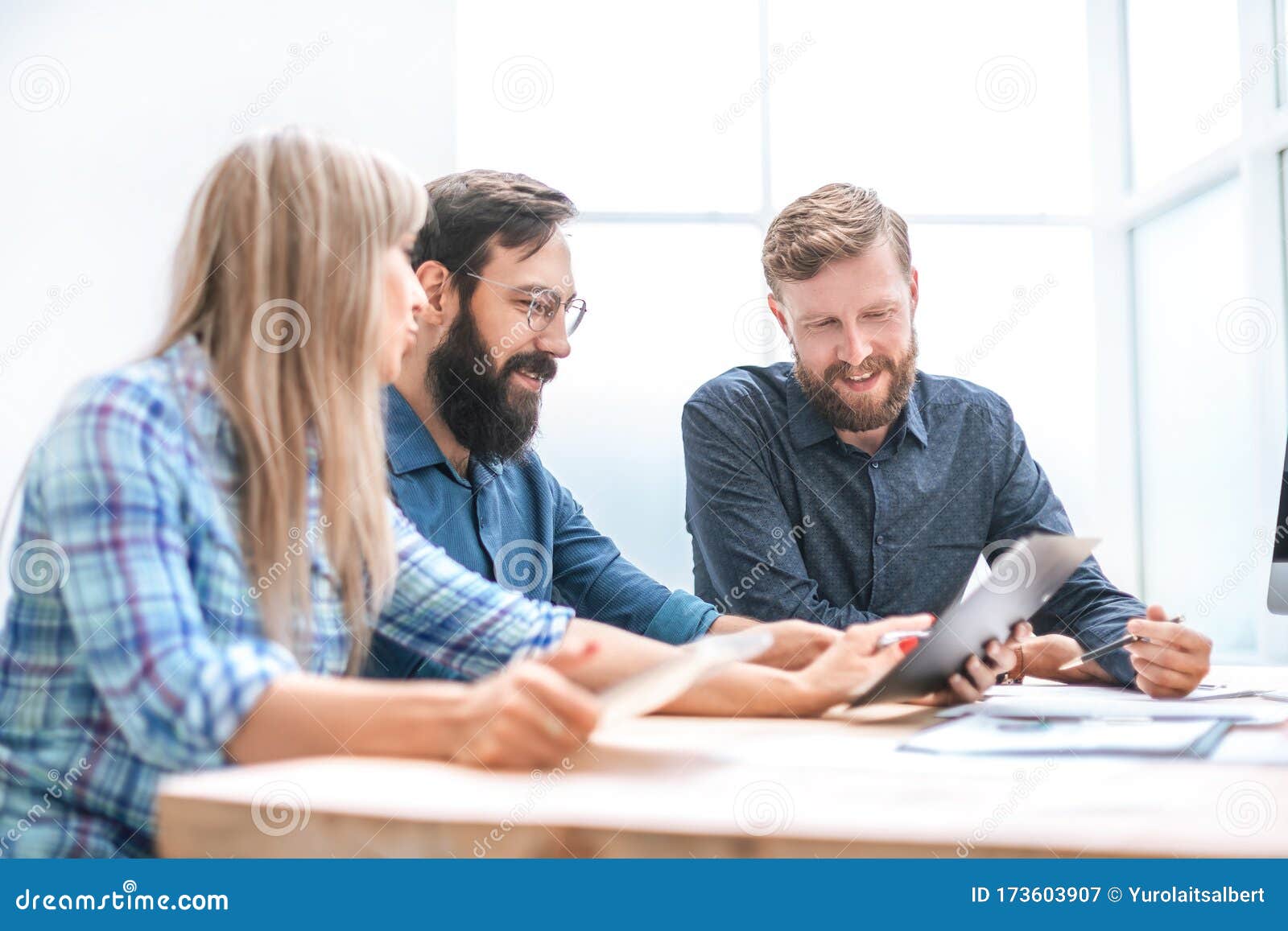 Close Up. a Group of Designers Discussing Documents for a New Project ...