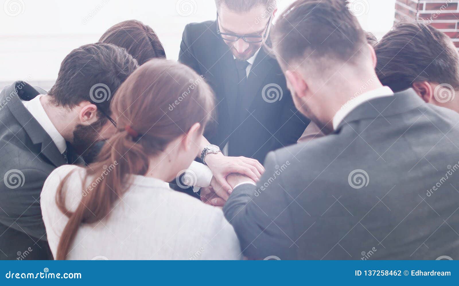 Close Up.a Group of Employees Folded Their Hands Together Stock Photo ...