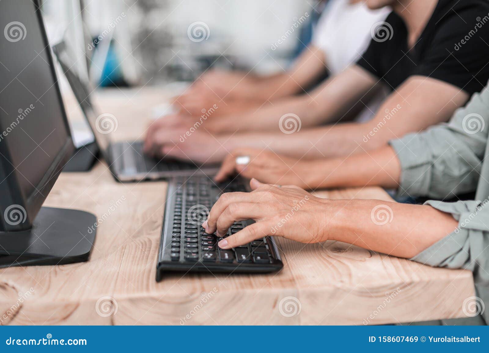 Close Up. a Group of Employees Sitting at a Table in a Computer Room ...