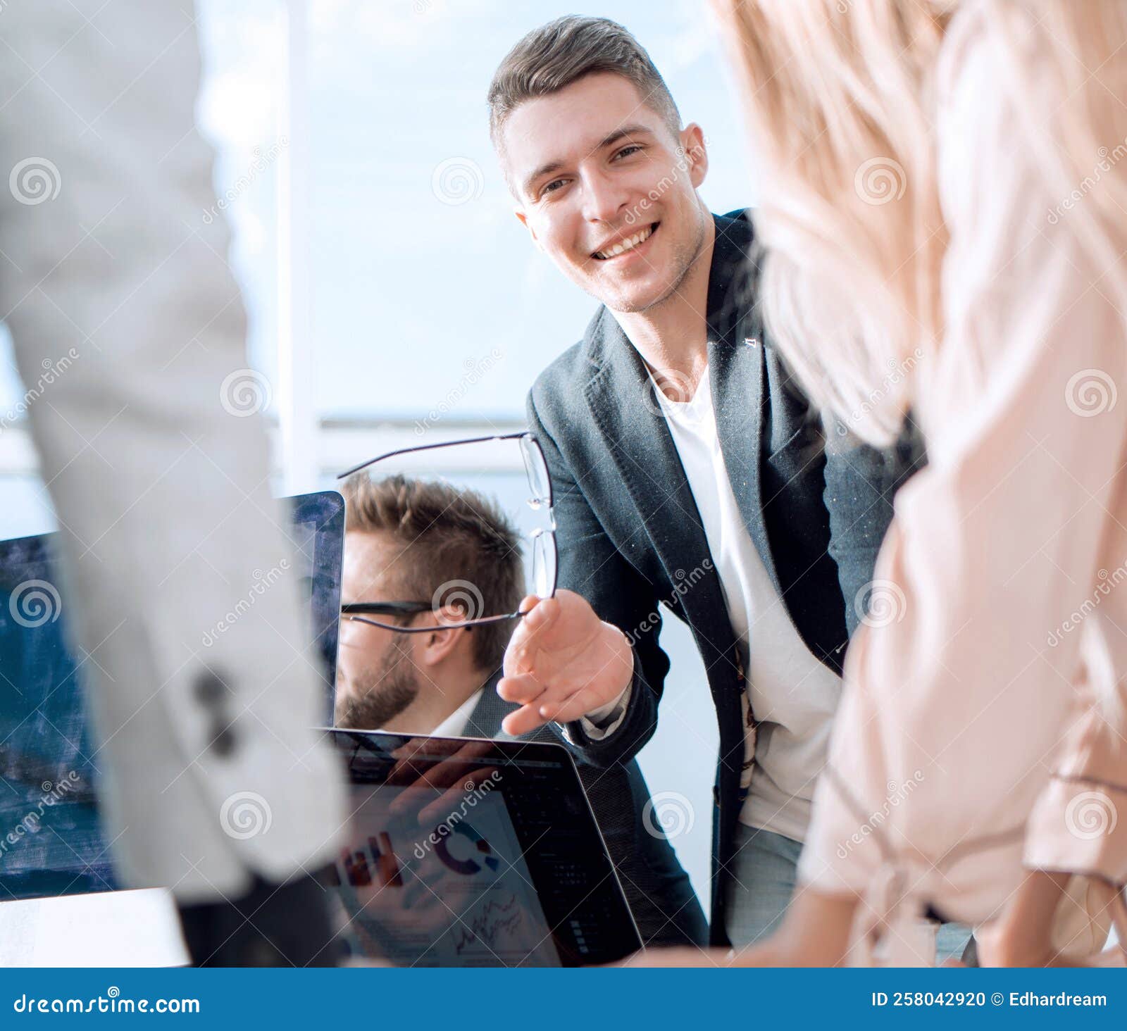 Close Up. Group of Office Employees Using a Laptop in the Office Stock ...