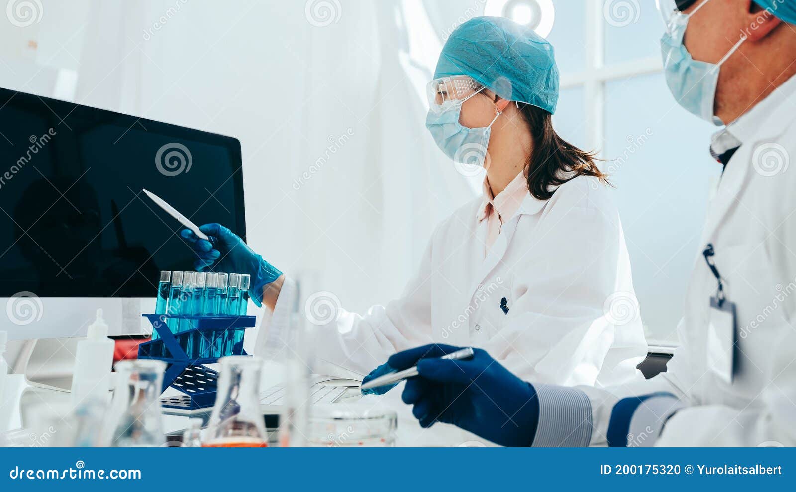 Group of Scientists Looking at a Computer Screen in the Laboratory ...