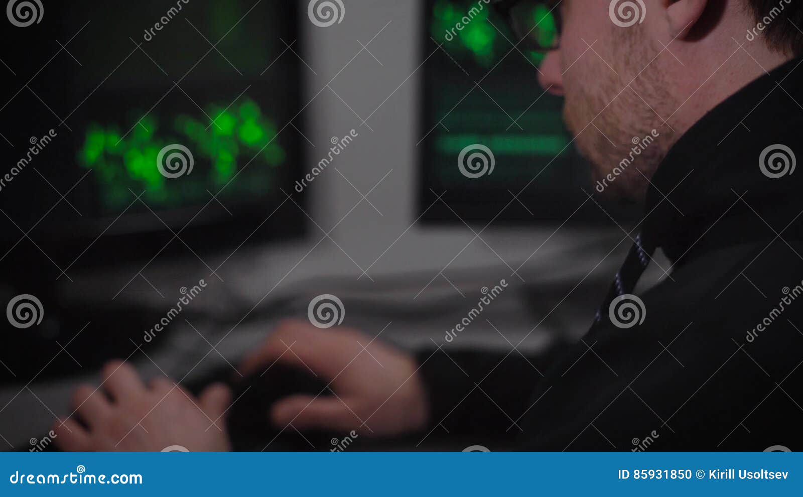 Close Up of Hacker Sitting at the Table with Computer Monitors and ...