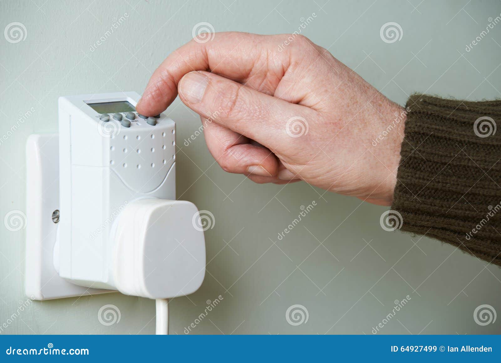 Close Up Of Hand Adjusting Timer Switch In Plug Socket Stock Image