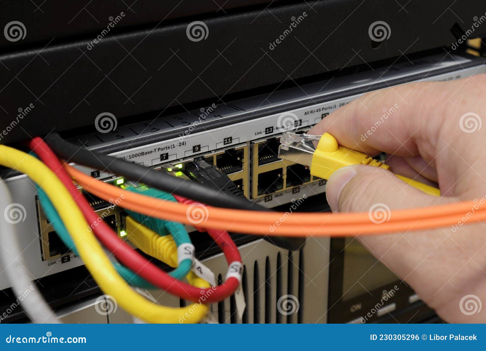 Close-up of a Hand that Connects a UTP Cable To the Switch. Computer ...