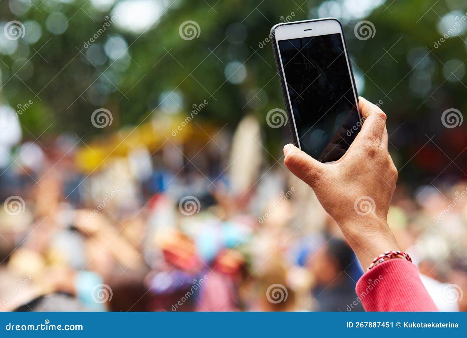 Close-up of a Hand from the Crowd Filming the Event on a Cell Phone ... Close-up of a Hand from the Crowd Filming the Event on a Cell Phone ...