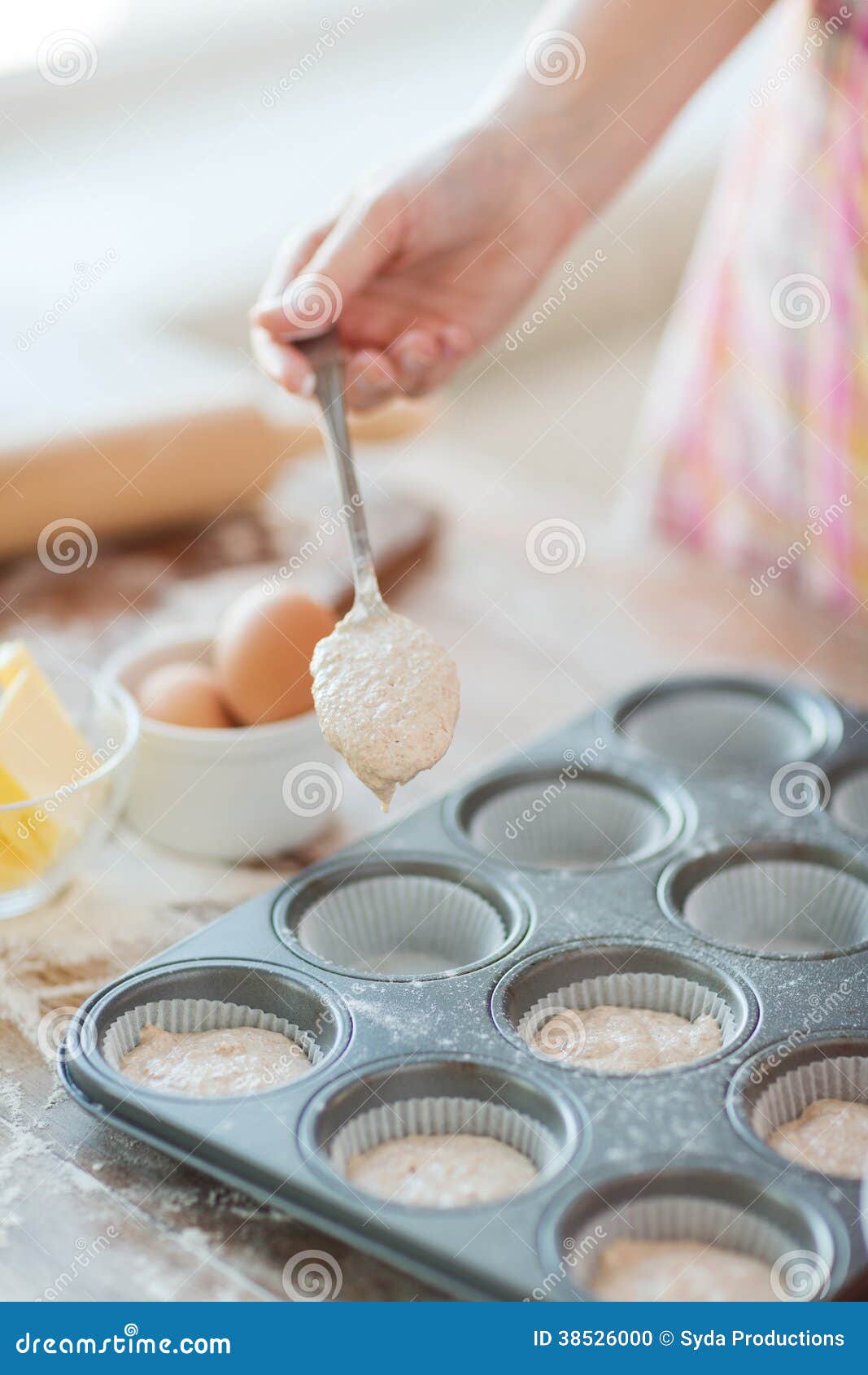Close Up of Hand Filling Muffins Molds with Dough Stock Photo - Image ...