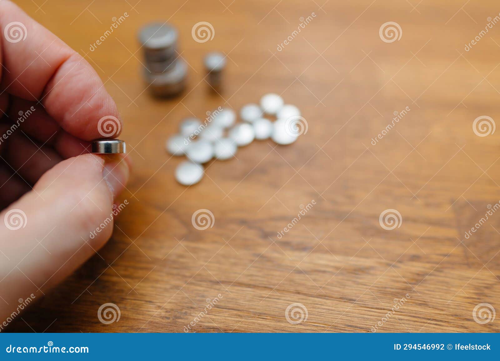 Close-up of Hand Holding Button Battery Stock Photo - Image of object ...