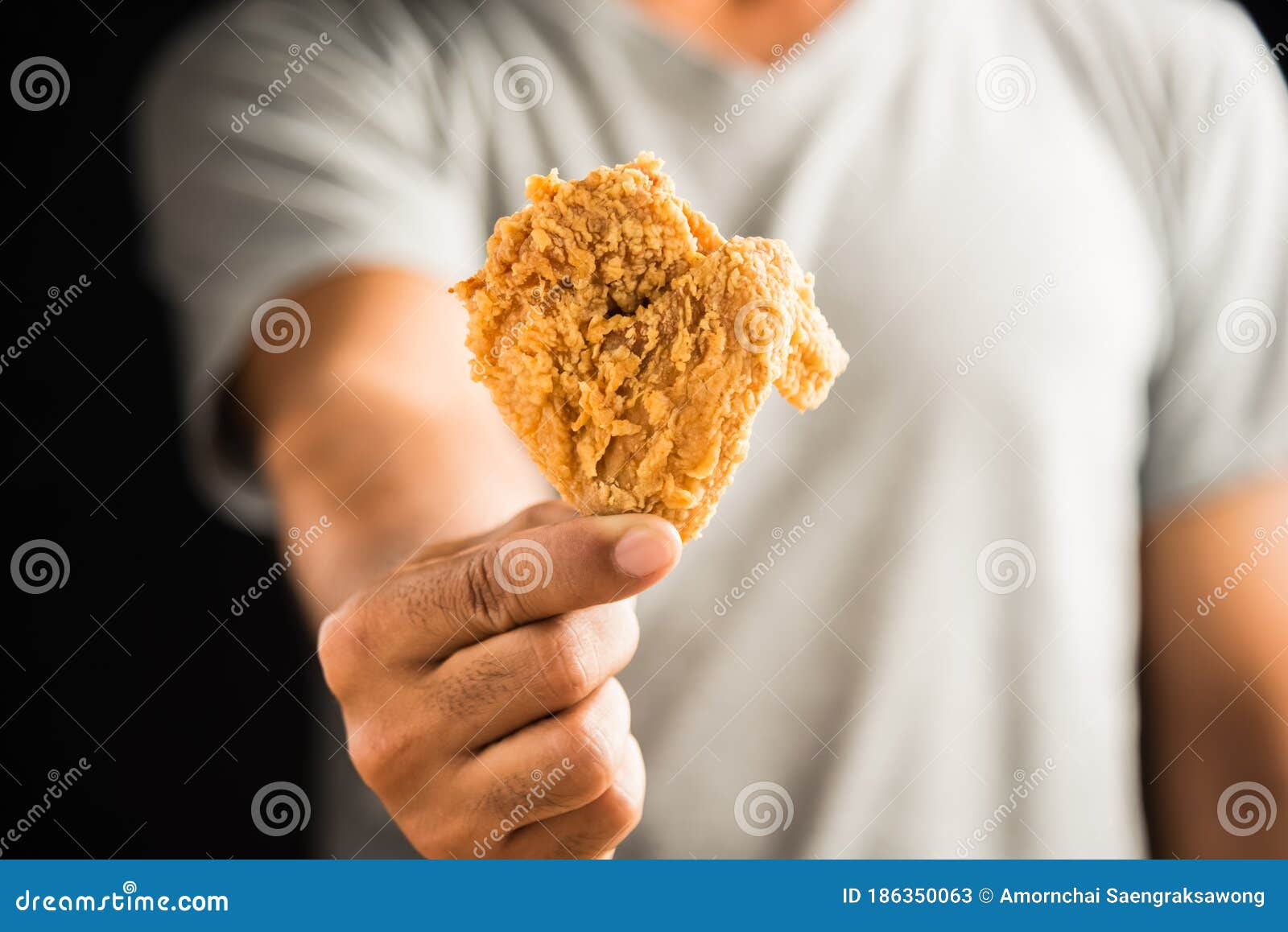 Close-up Hand Holding Fried Chicken on Black Background Stock Image ...