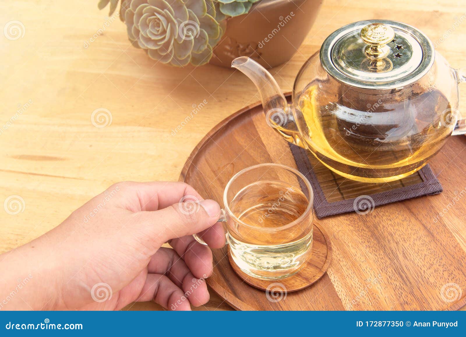 Close Up Hand Holding a Glass Cup of Tea on the Table Stock Photo ...