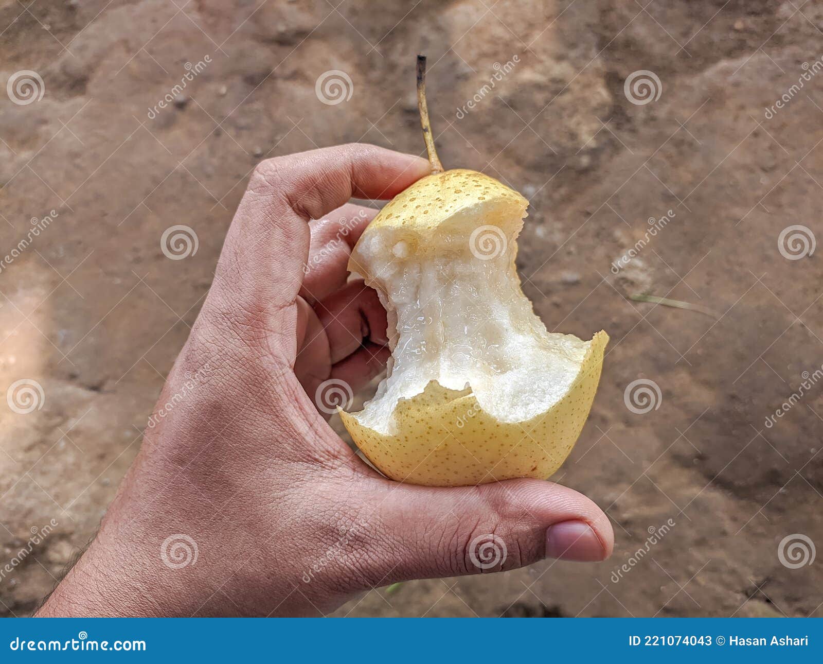 Close-up of Hand Holding Pear with Bite Marks Stock Image - Image of ...