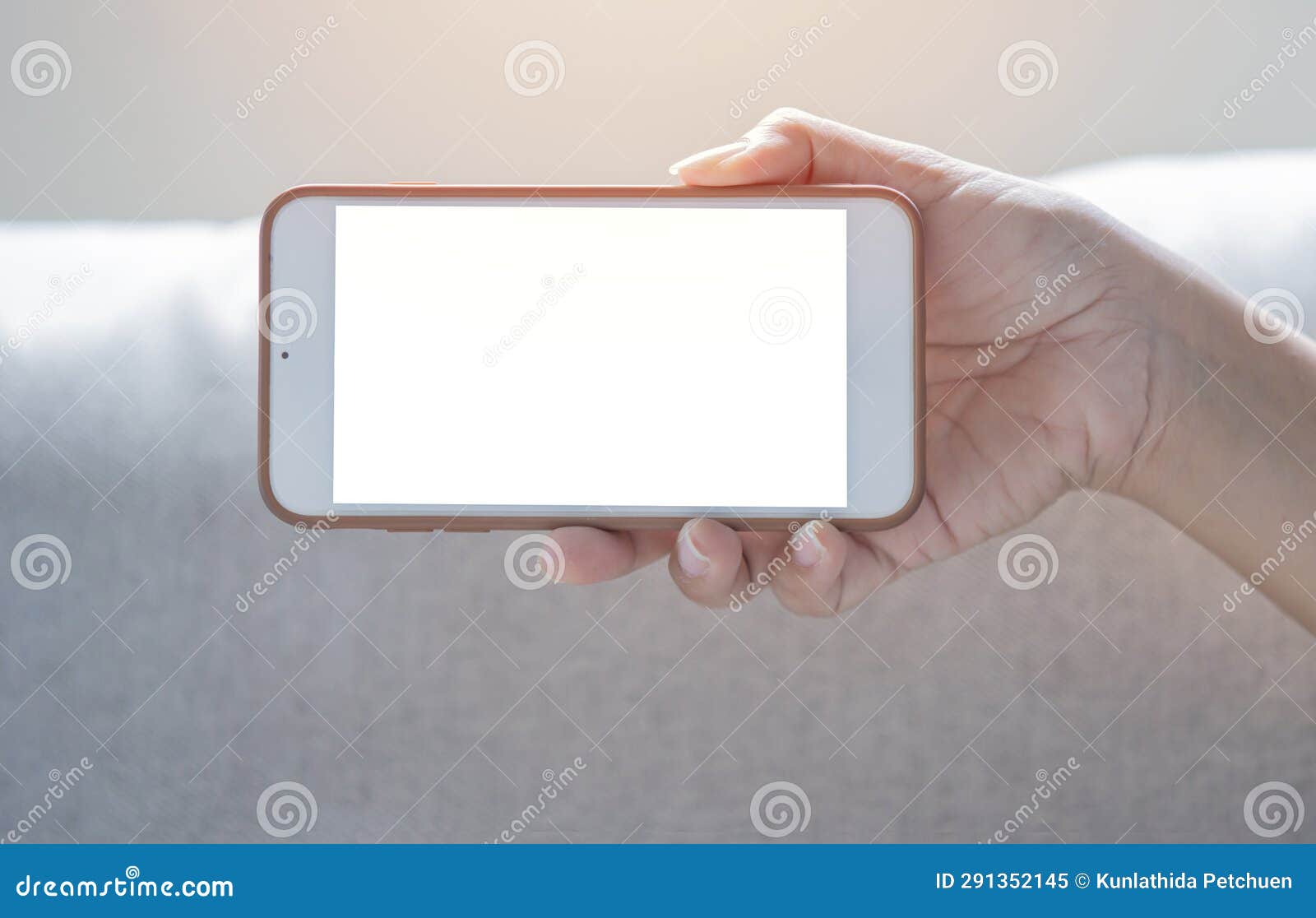 Close Up of Hand Holding Phone Facing Camera on Light Beige Sofa ...