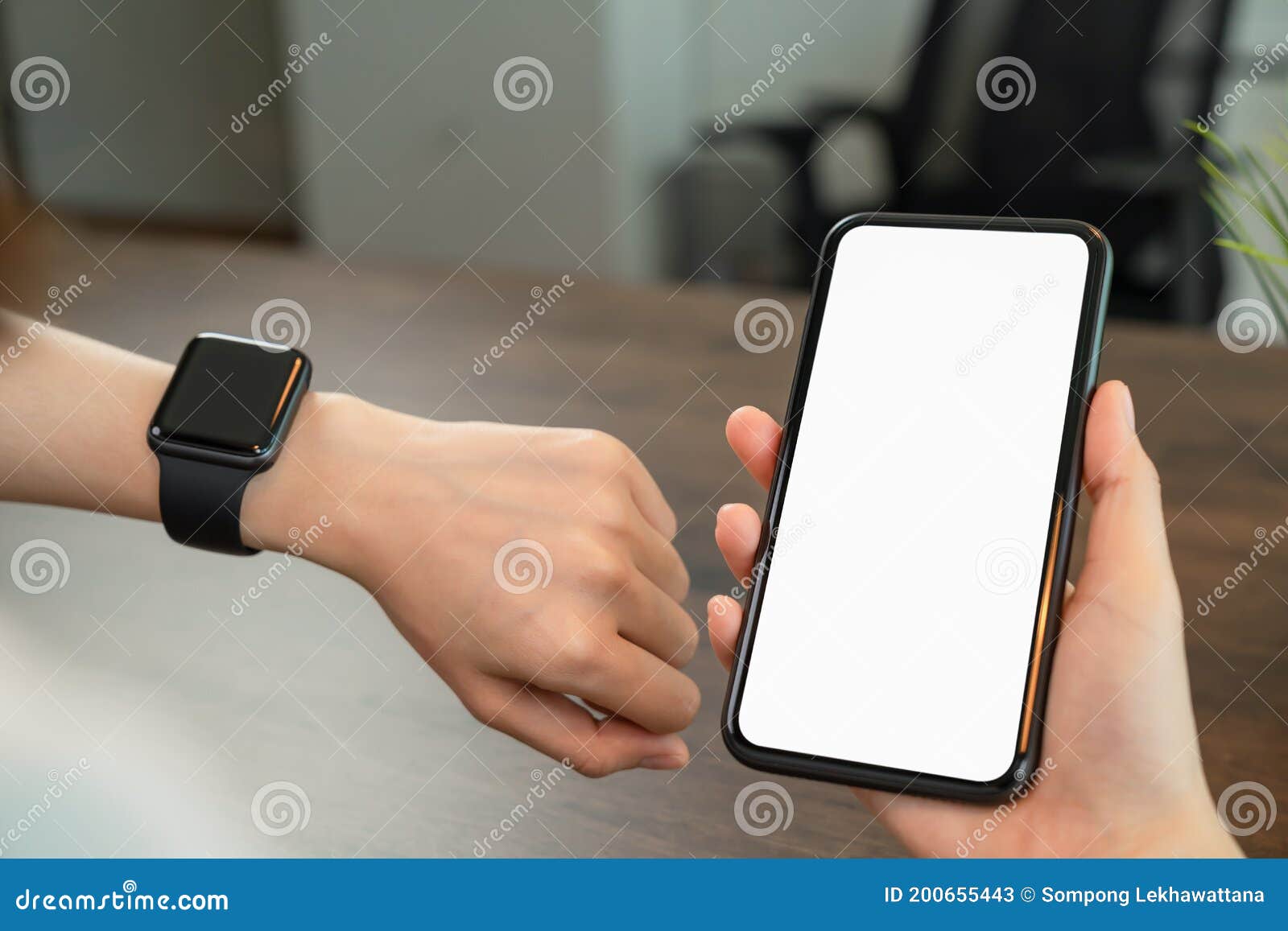 Close-up of Hand Holding Smartphone and Looking Smartwatch. Stock Image ...