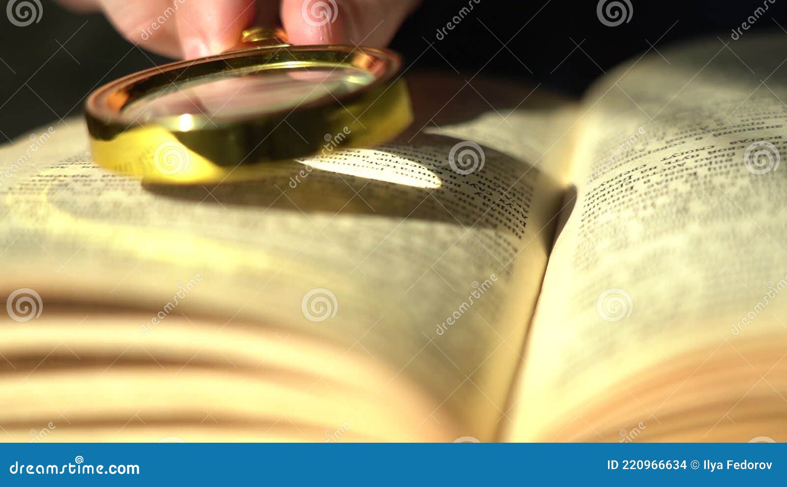 Close-up Hand with a Magnifying Glass and an Old Book. Stock Footage ...