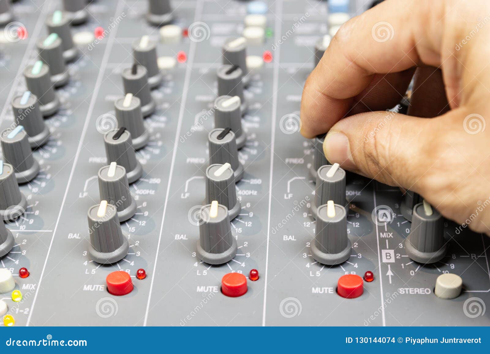 Close-up Hand of Man Control Mixing Console of a Big HiFi System the ...