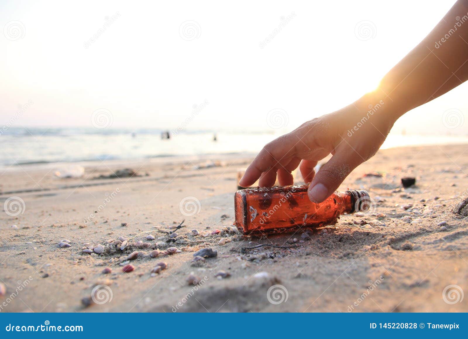 Close Up Hand Pick Glass Bottle on the Beach Stock Photo - Image of ...