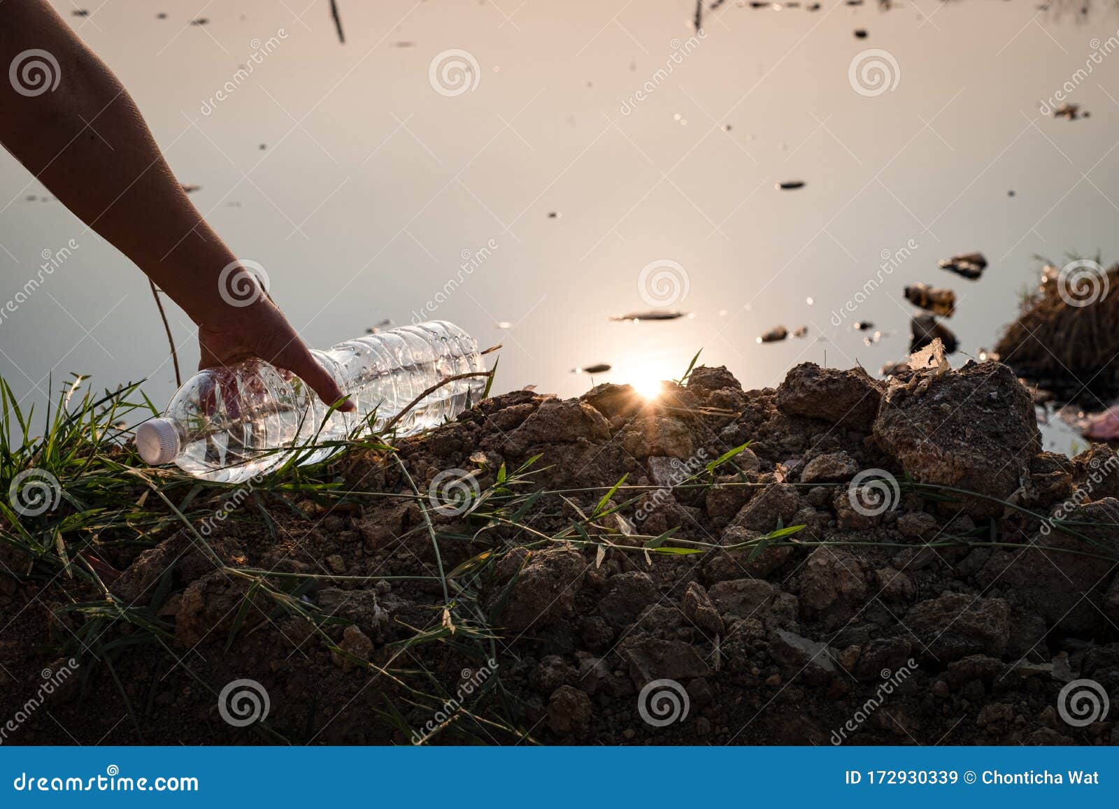 Hand Picking Up A Clear Plastic Bottle Drop On The Ground With Polluted ...