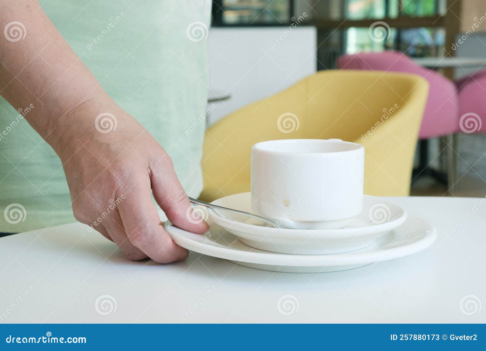 Close-up of a Hand Picking Up a Stack of Plates and a Dirty Coffee Cup ...