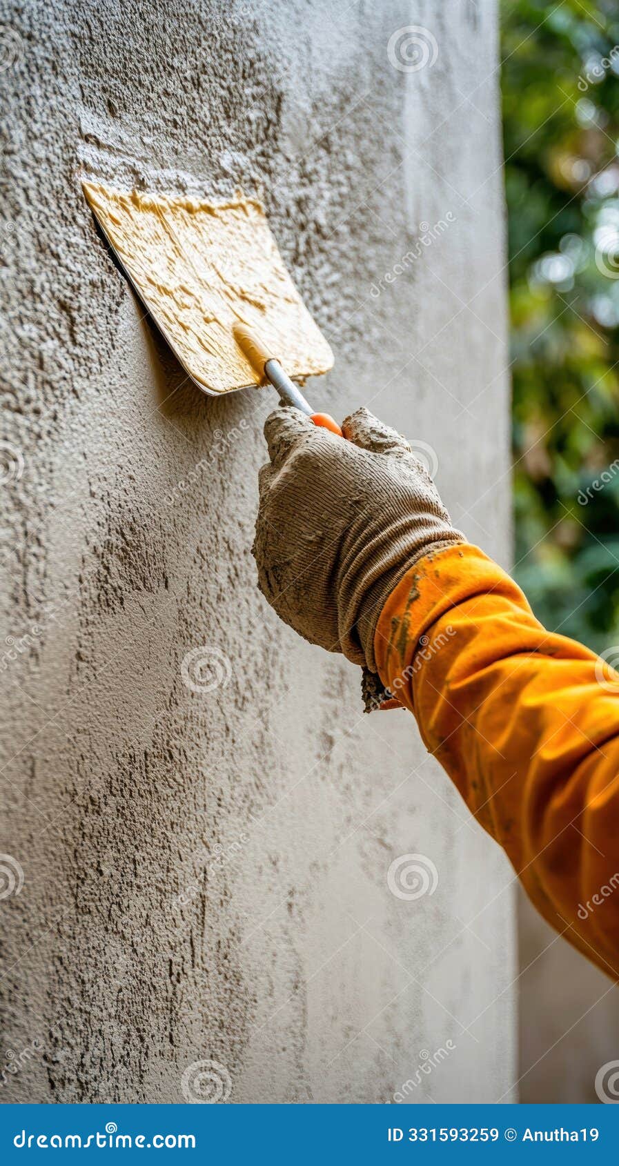 Close-up of a Hand in Protective Gear Using a Trowel To Apply Plaster ...