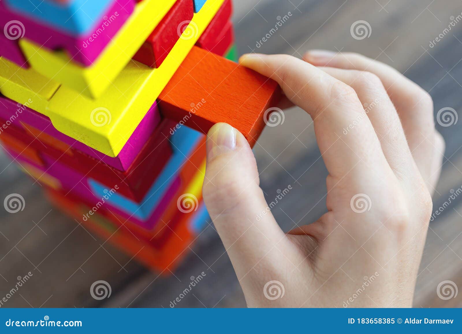 Close Up of a Hand Pulling a Colorful Jenga Block from a Big Pile. Fun ...
