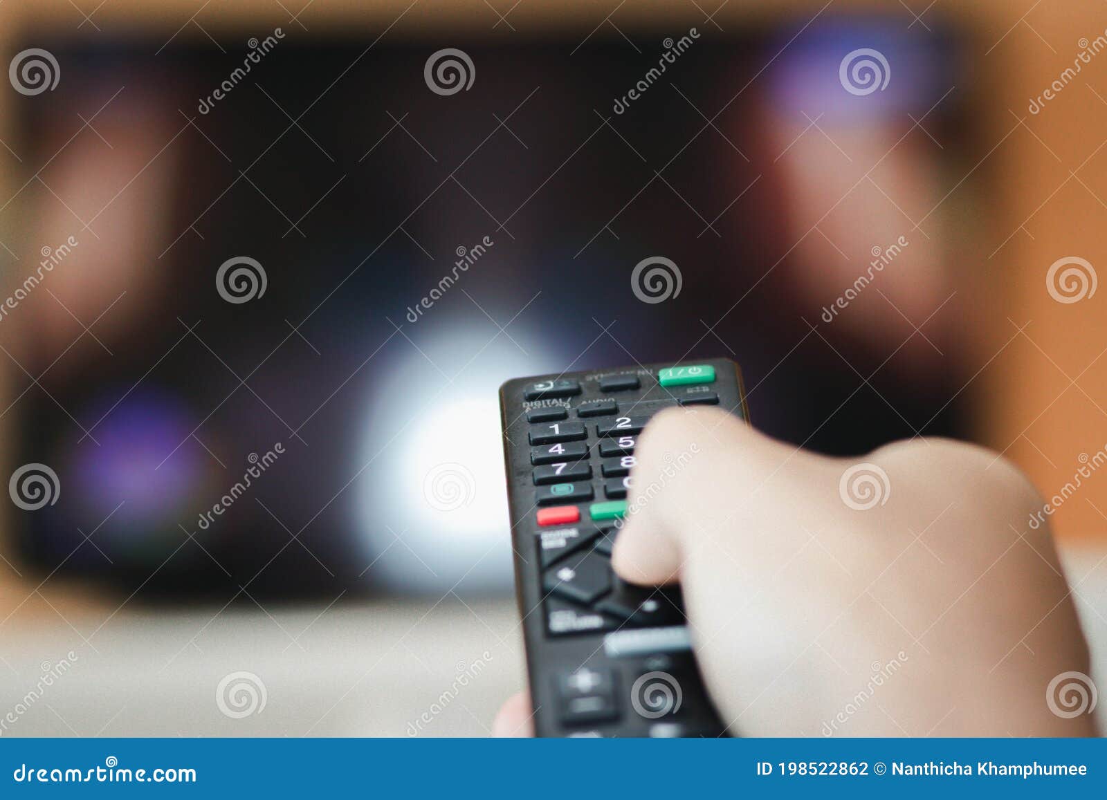 Close-up of Hand with the Remote Control Television and Presses the ...