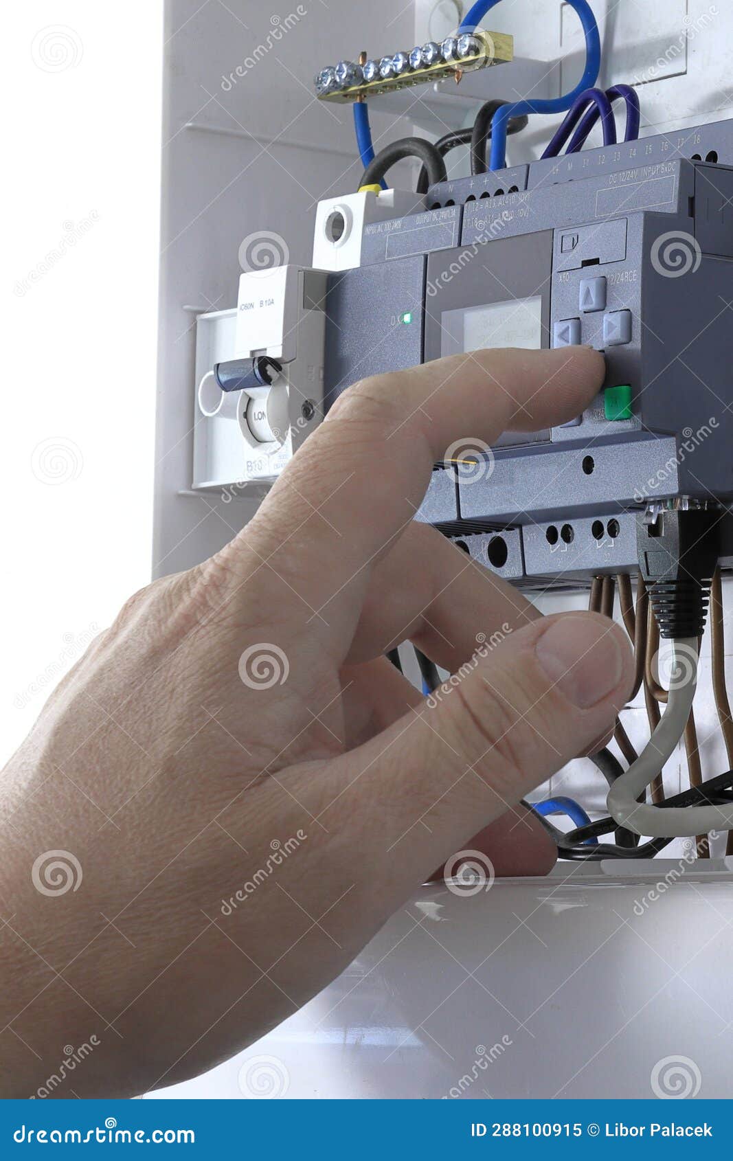 Close Up of a Hand Setting Up a PLC. Automatic Control of Production ...