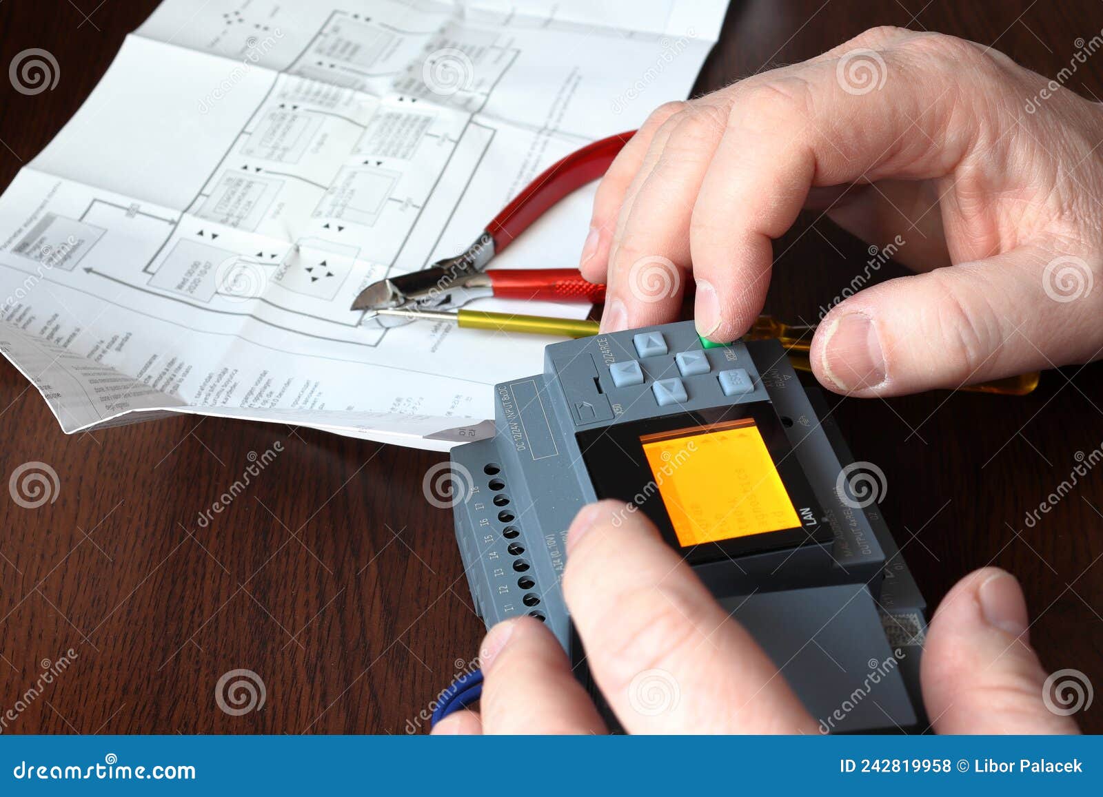 Close-up of a Hand Setting Up a Mini PLC. Automatic Control System ...