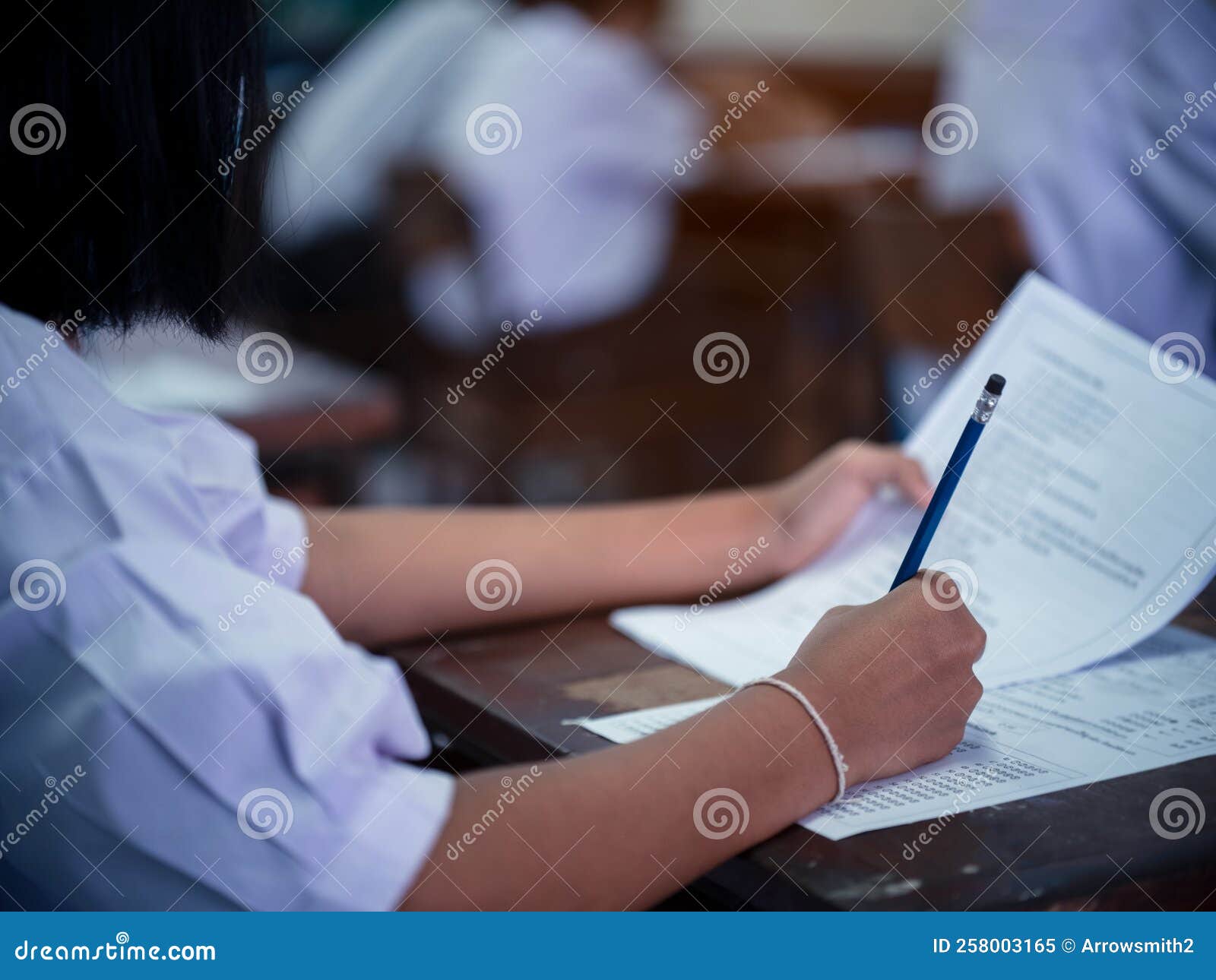 Close Up Hand of Students Reading and Taking Exam Sheets Exercises ...