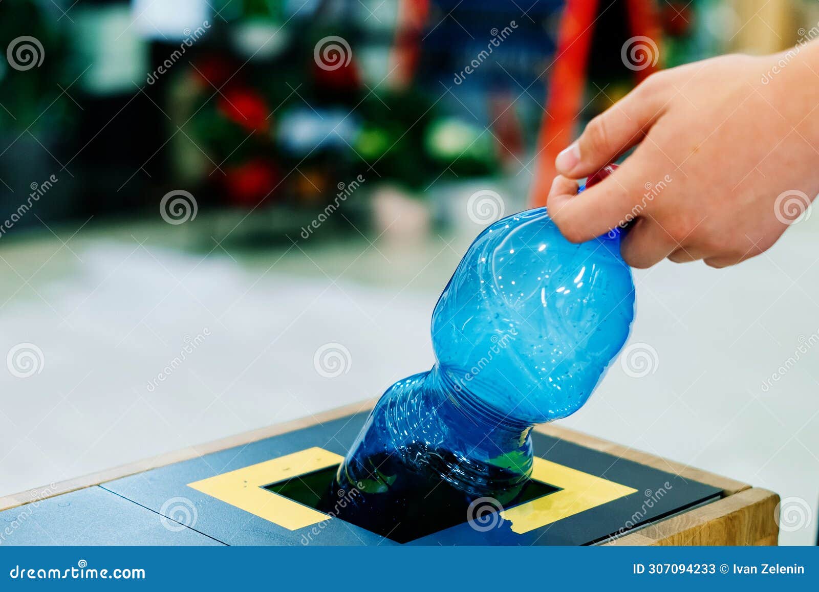 Close Up Hand Throwing Empty Plastic Water Bottle into Recycling Bin ...
