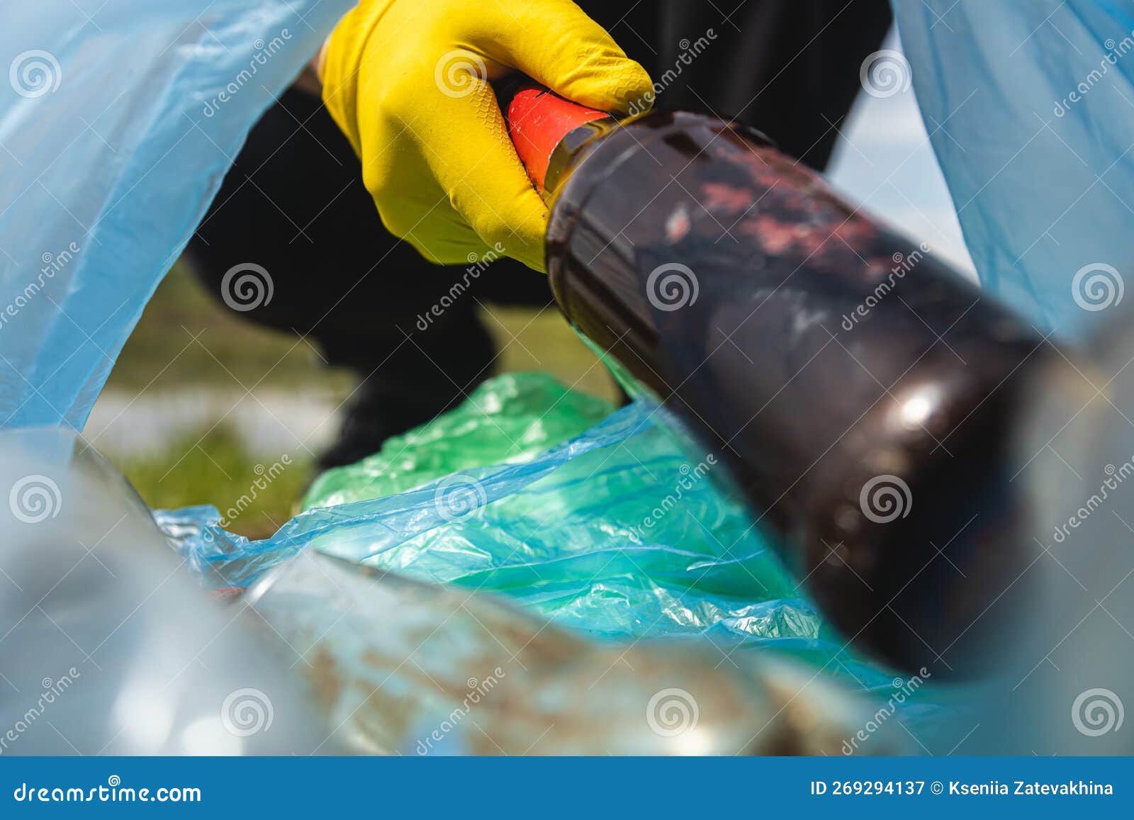 Close-up of a Hand Throwing Garbage into a Plastic Bag. View from ...
