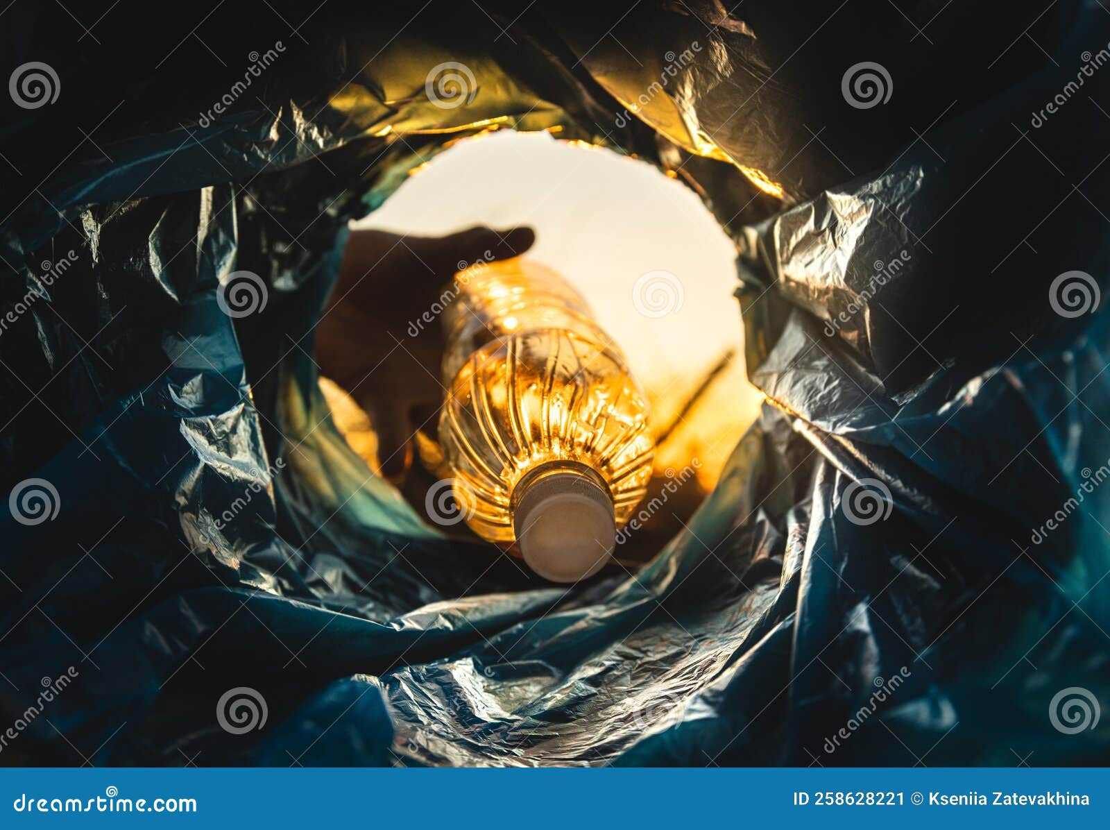 Close-up of a Hand Throwing a Plastic Bottle into the Trash Can. Close ...