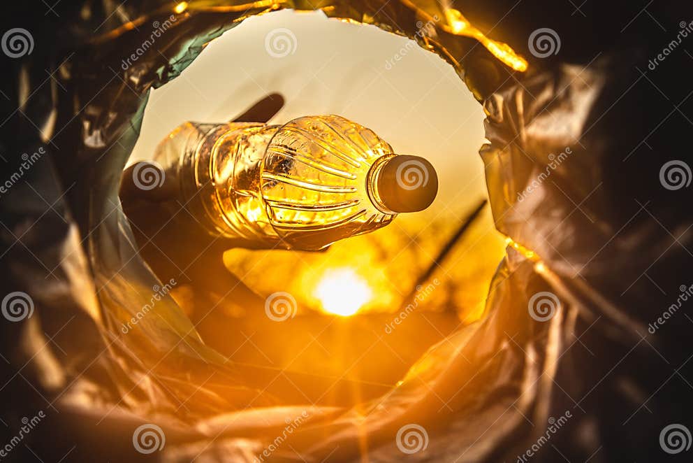 Close-up of a Hand Throwing a Plastic Bottle into the Trash Can. Close ...