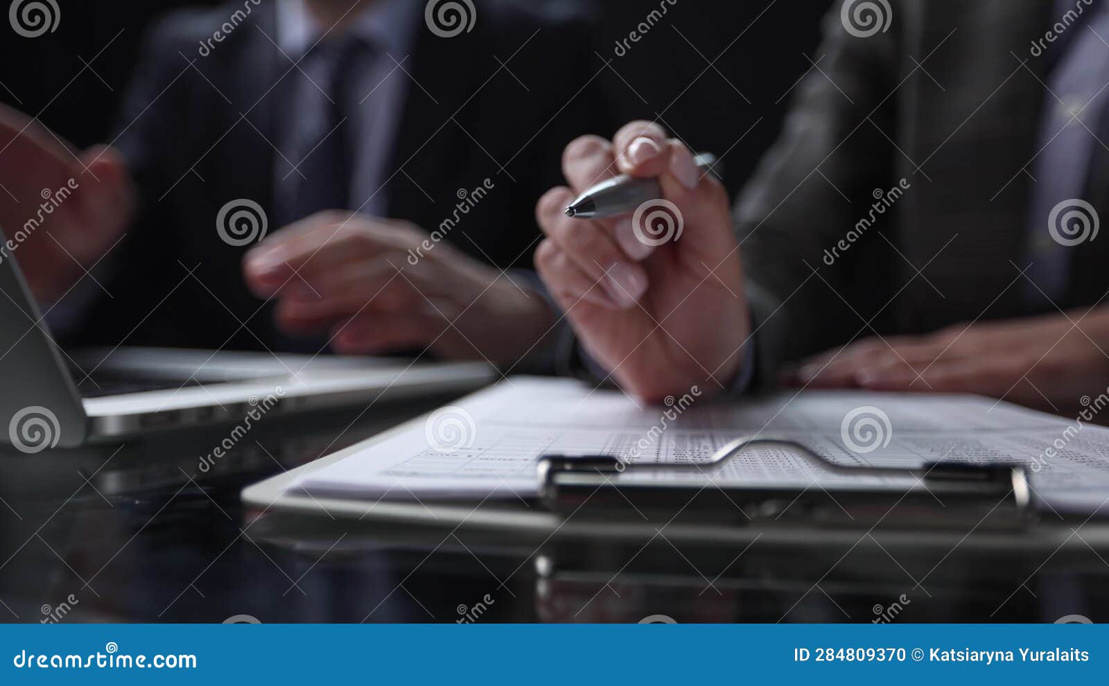 Close-up of a Hand Using a Writing Pen with a Paperwork Questionnaire ...