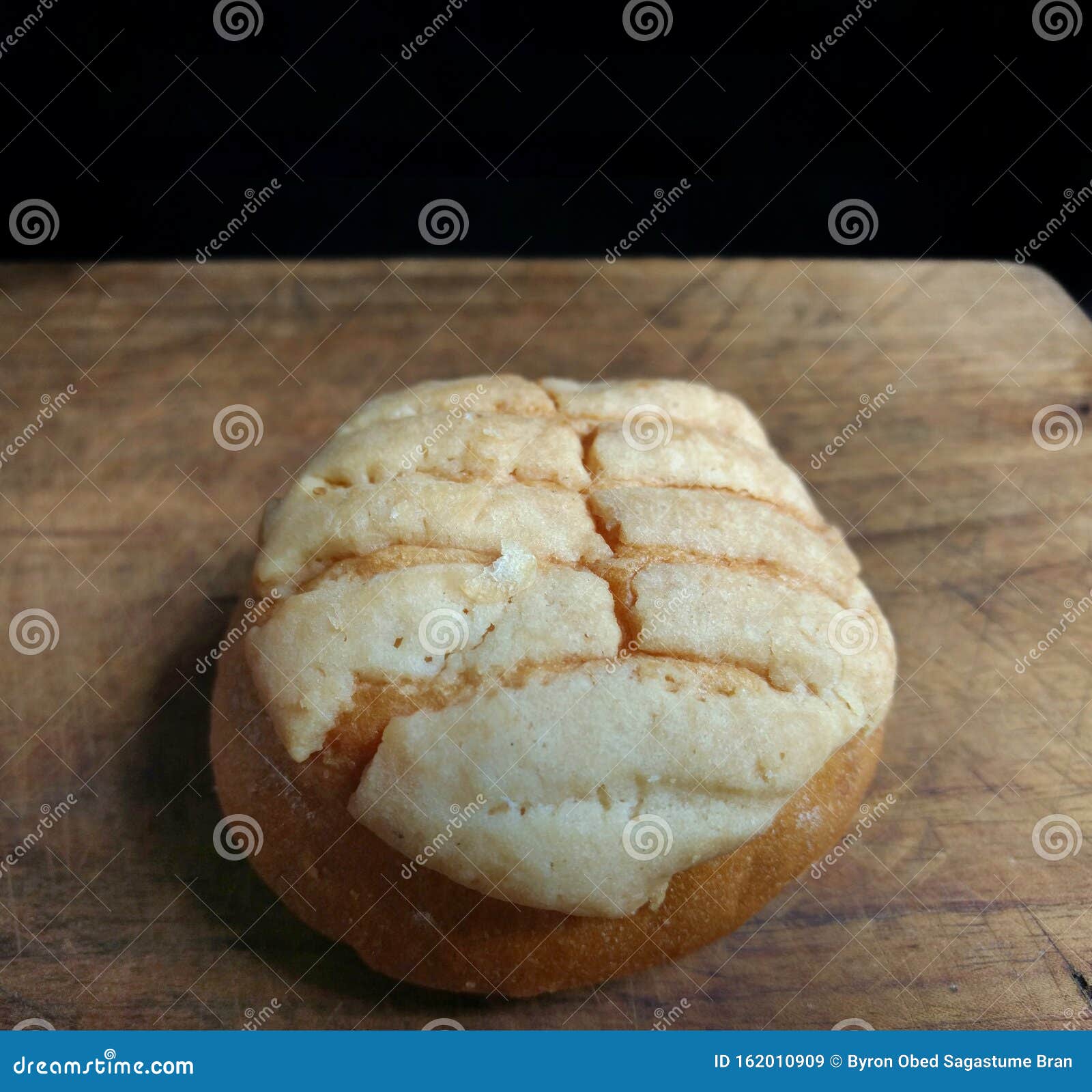 Close-up of Handmade Shell Bread on Wooden Board with Black Background ...