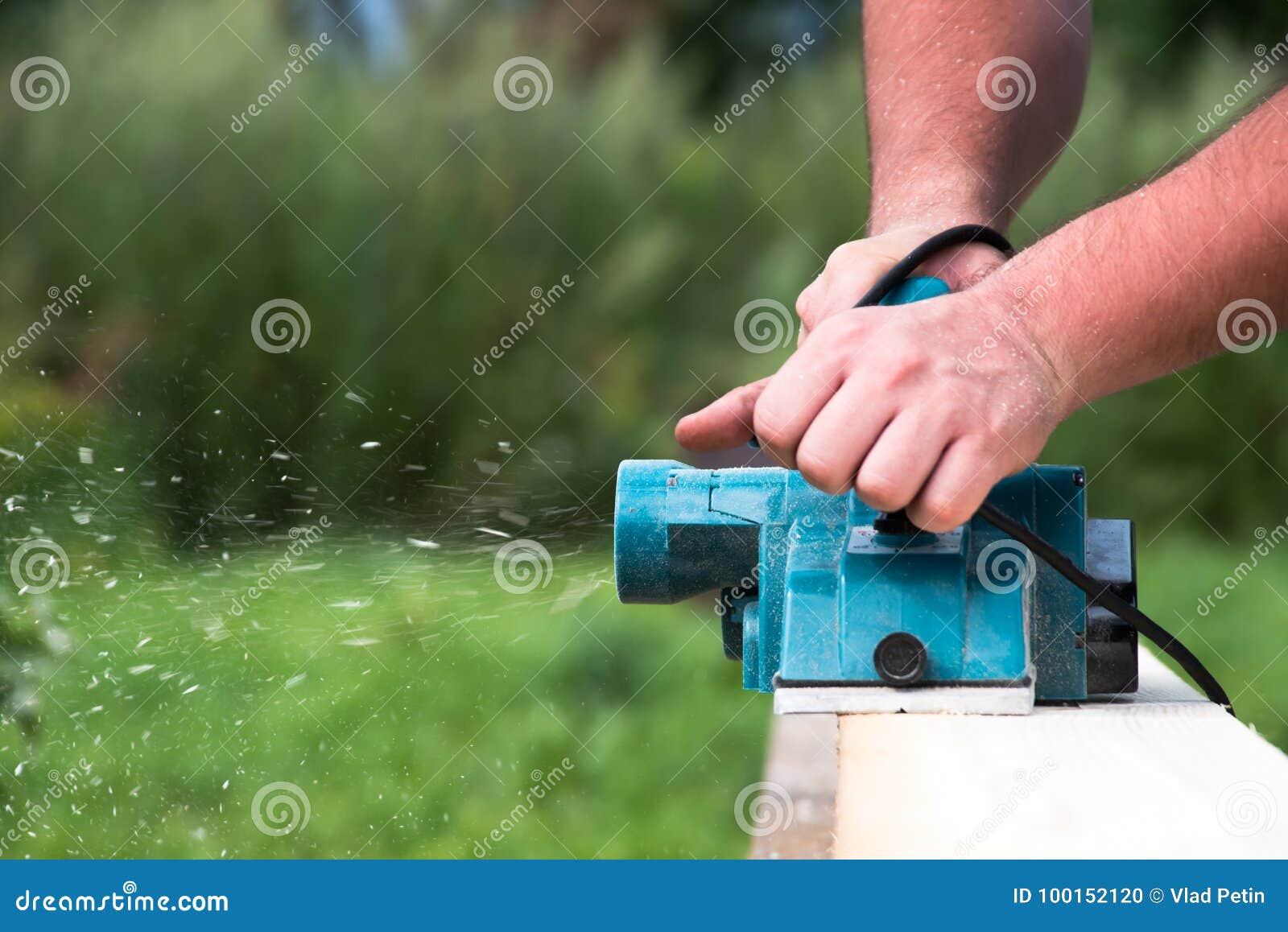 Close Up Hands of Carpenter Working with Electric Planer on Wooden ...