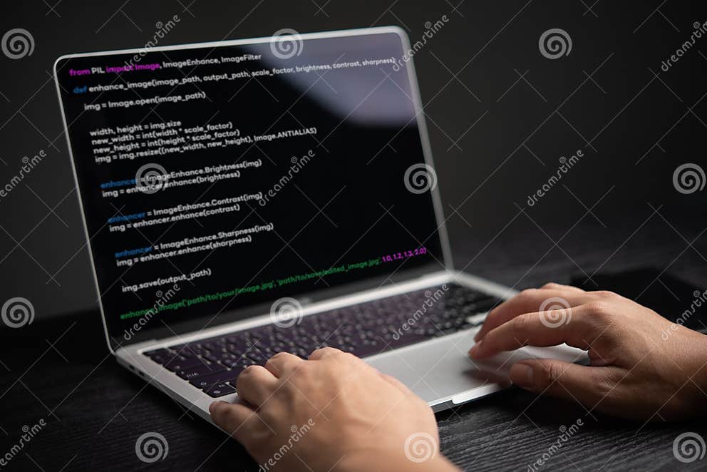 Close-up of Hands Coding on Laptop, Displaying Programming Interface ...