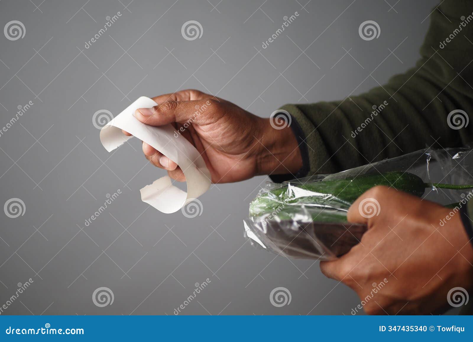 Close-Up of Hands Holding Receipt and Grocery Packet Stock Photo ...