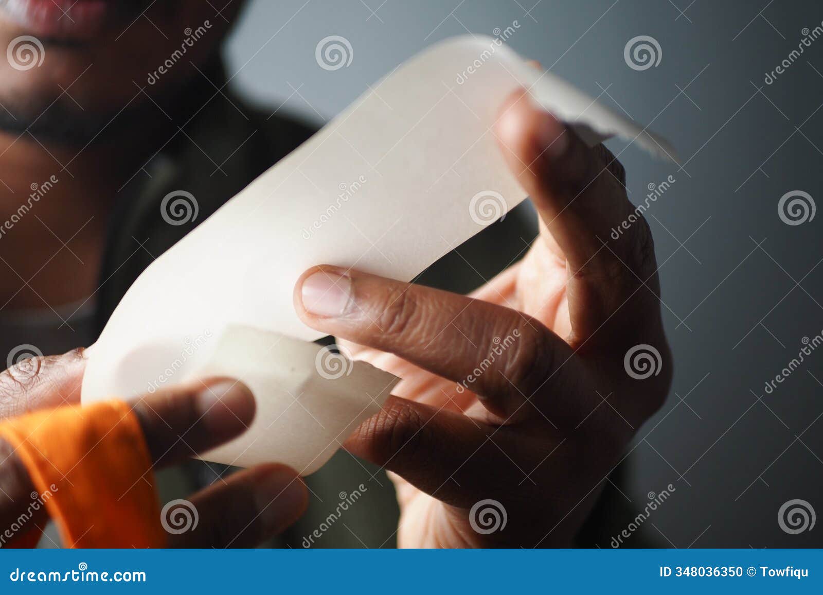Close-Up of Hands Holding Receipt and Grocery Packet Stock Photo ...