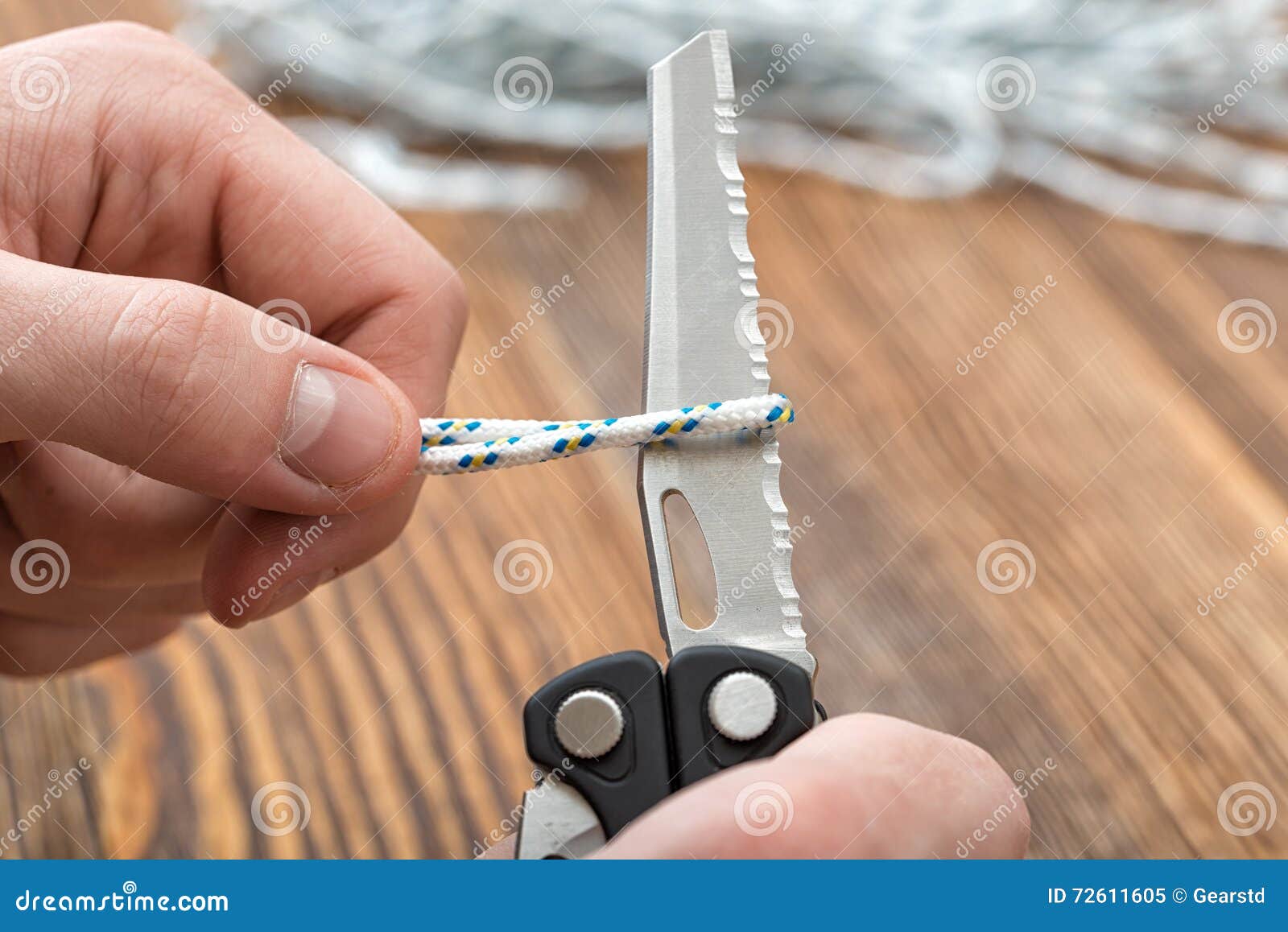 Close-up Hands of Man Cuts the Rope Using Multi Tool with Serrated ...
