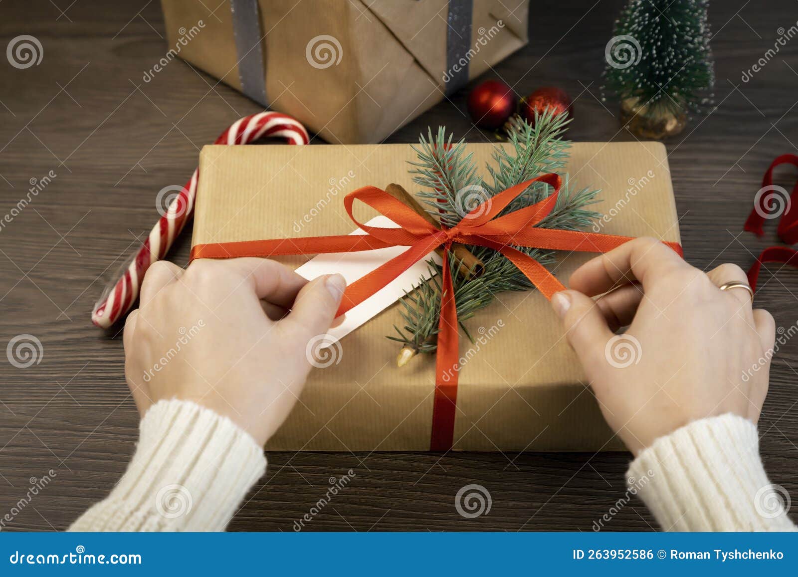 Close-up of Hands Tying Red Ribbon on Gift Box. Stock Photo - Image of ...